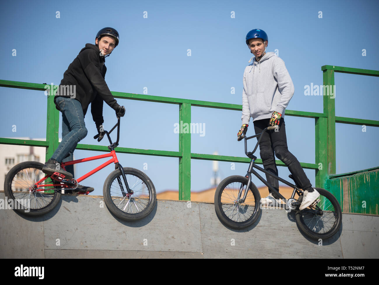 Two men on bicycle riding in the skatepark Stock Photo - Alamy