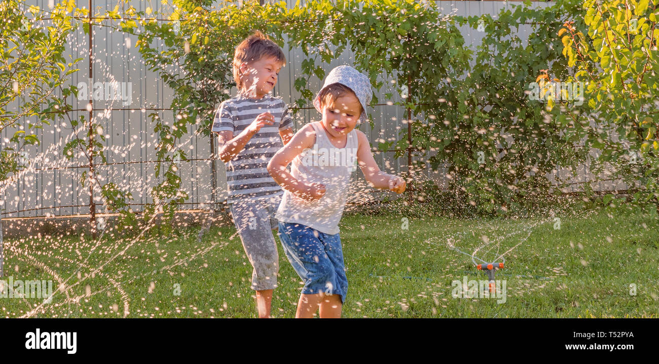 Happy children playing outdoor. Joyful siblings having fun on sunny ...