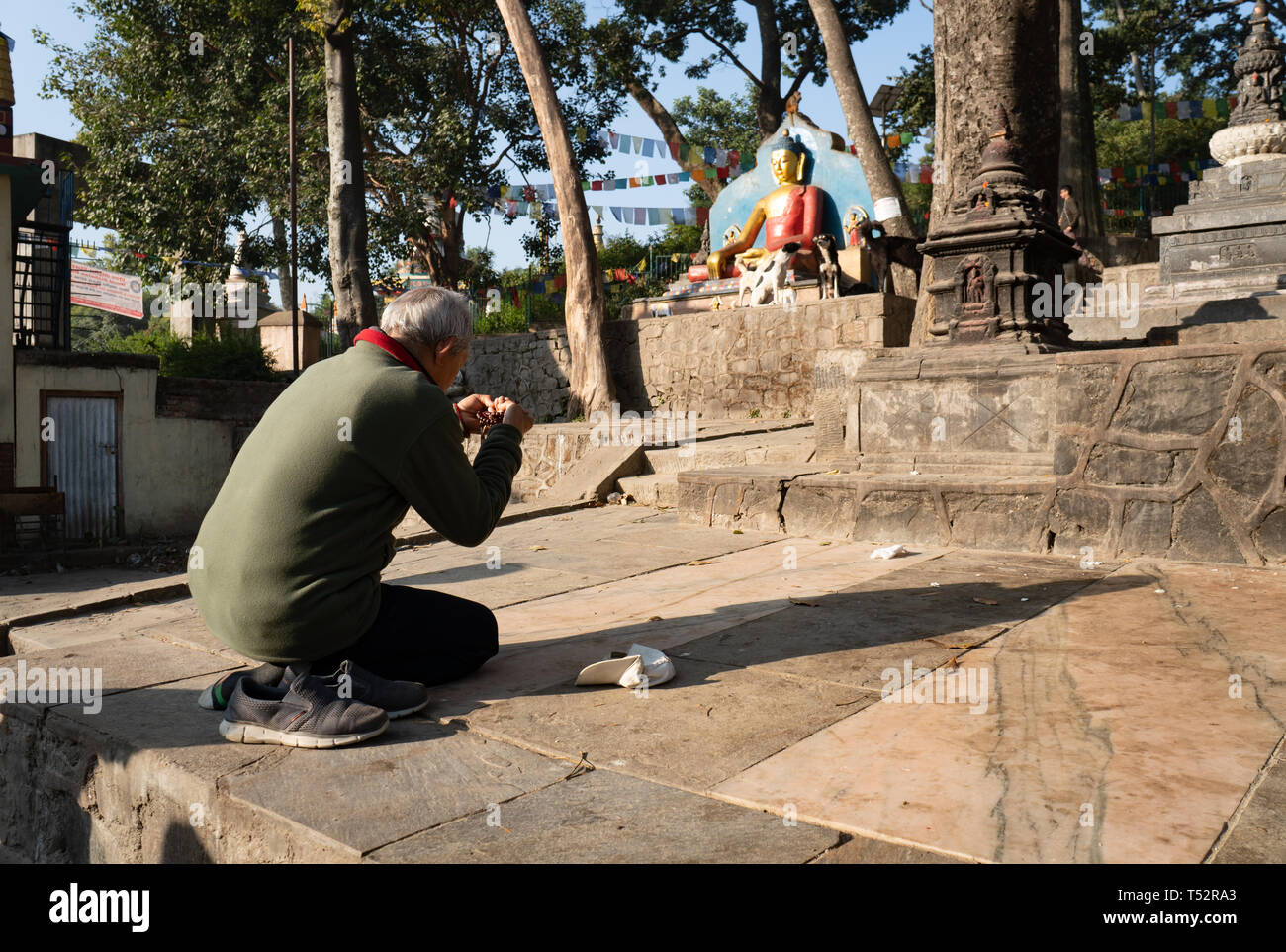 Kathmandu, Nepal - November 11, 2017: An old man praying to Bhagwan Pau ...