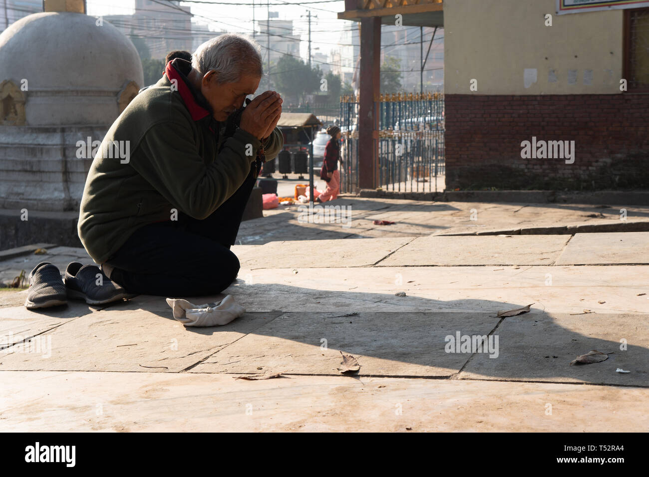 Kathmandu, Nepal - November 11, 2017: An old man praying to Bhagwan Pau ...