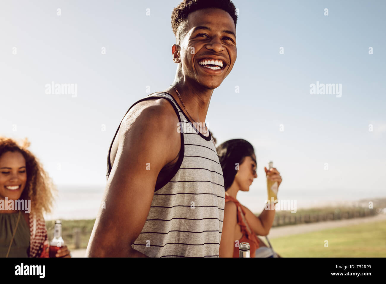 Happy young man hanging out with friends on a summer day. Smiling man ...
