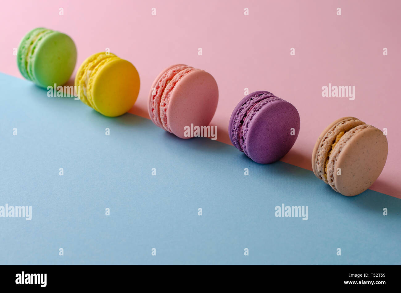 Sweet colorful cookies macaroons or macarons on colorful pastel colors ...