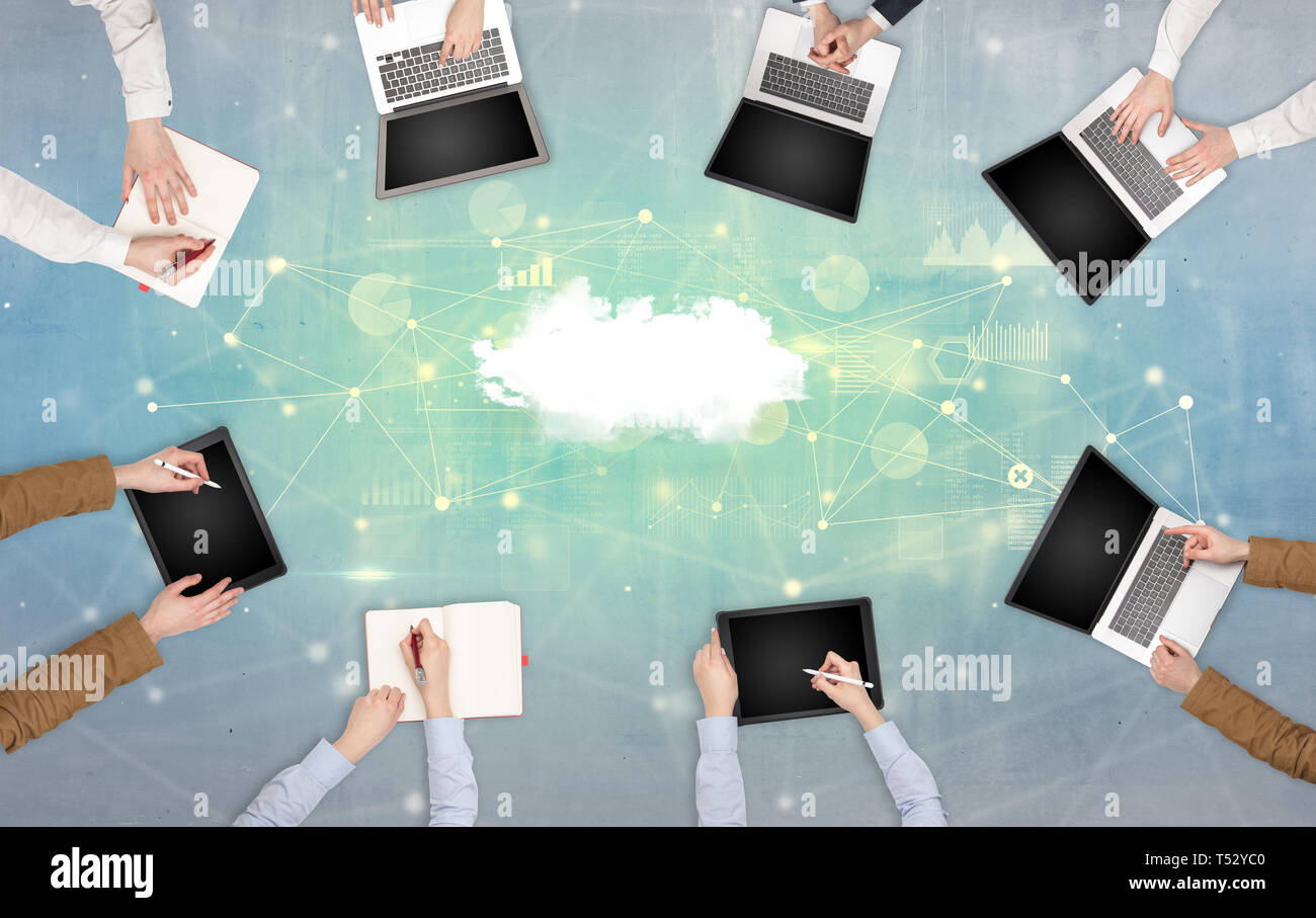 Group of people with devices in hands working on reports with online ...