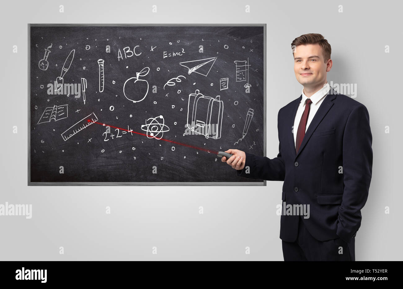 Handsome young teacher with laser pointer teaching Stock Photo - Alamy