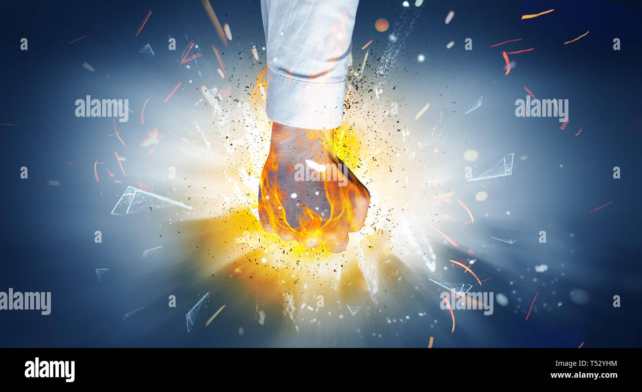 Hand hits strongly and makes fire beam around Stock Photo - Alamy