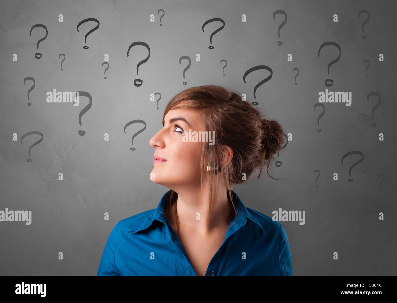 Person with question marks around face Stock Photo - Alamy