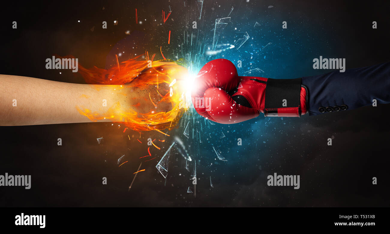 Two hands fighting and breaking glass into small pieces with fire and ...