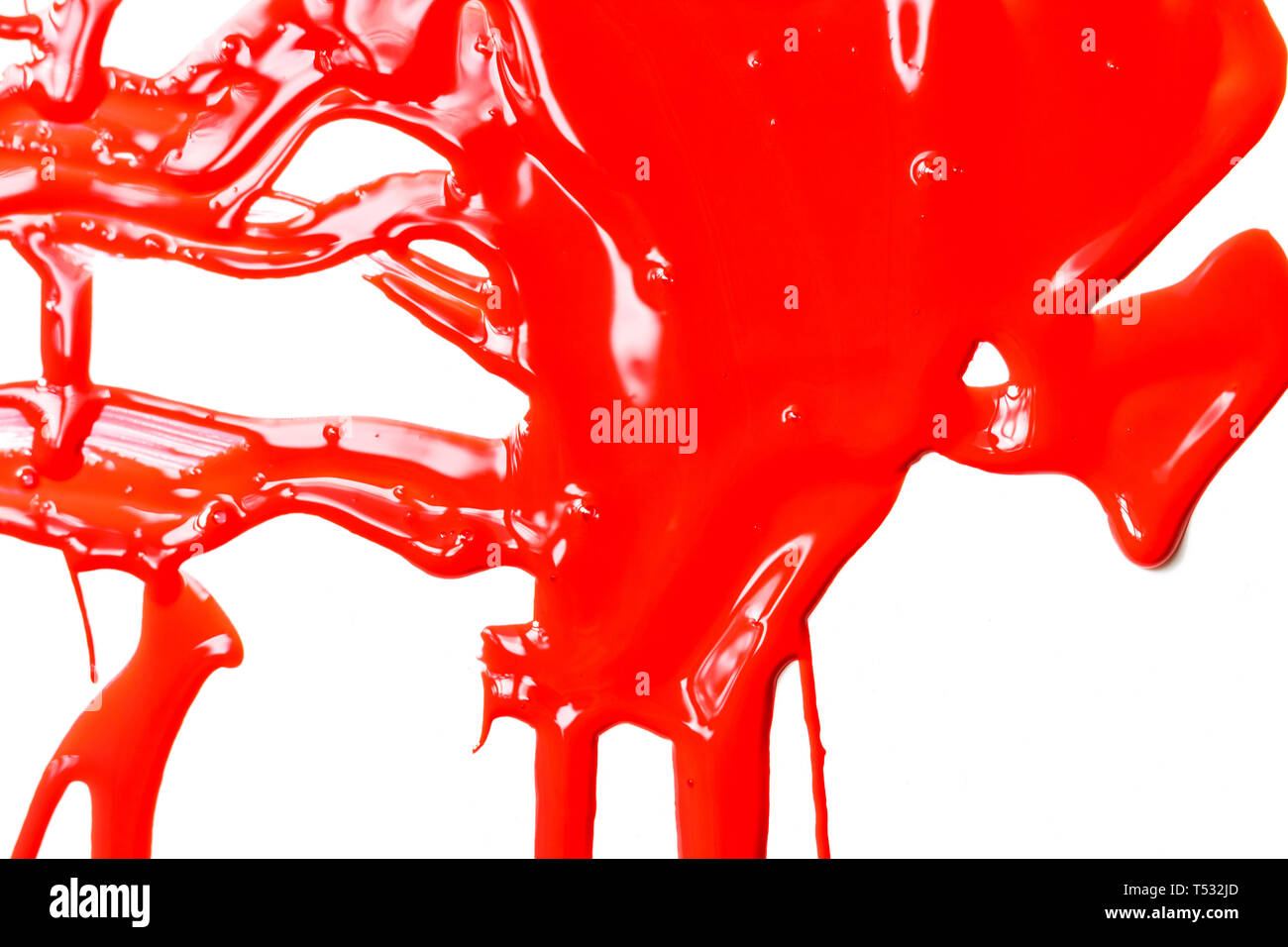 Thick red paint on a white background. Paint flows Stock Photo - Alamy