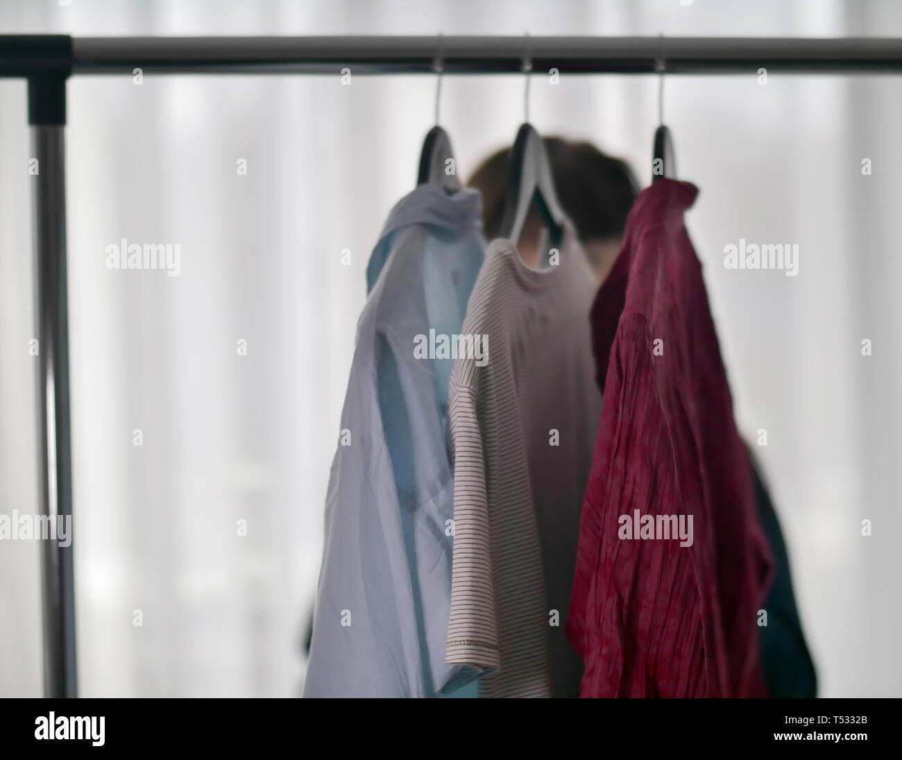 Hangers on hanging rail hi-res stock photography and images - Alamy