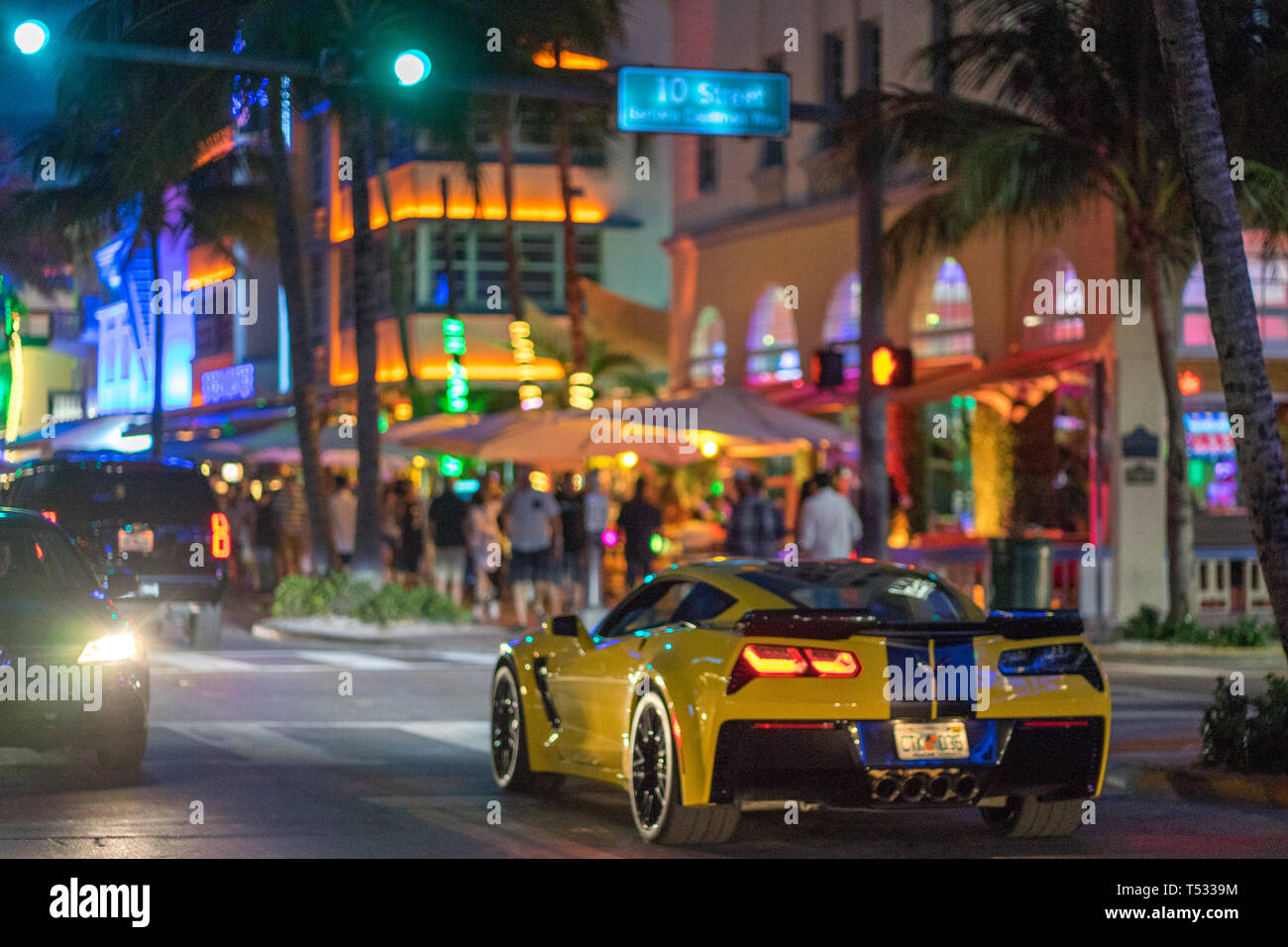 Yellow and Black Corvette Car driving down Ocean Drive, South Beach ...