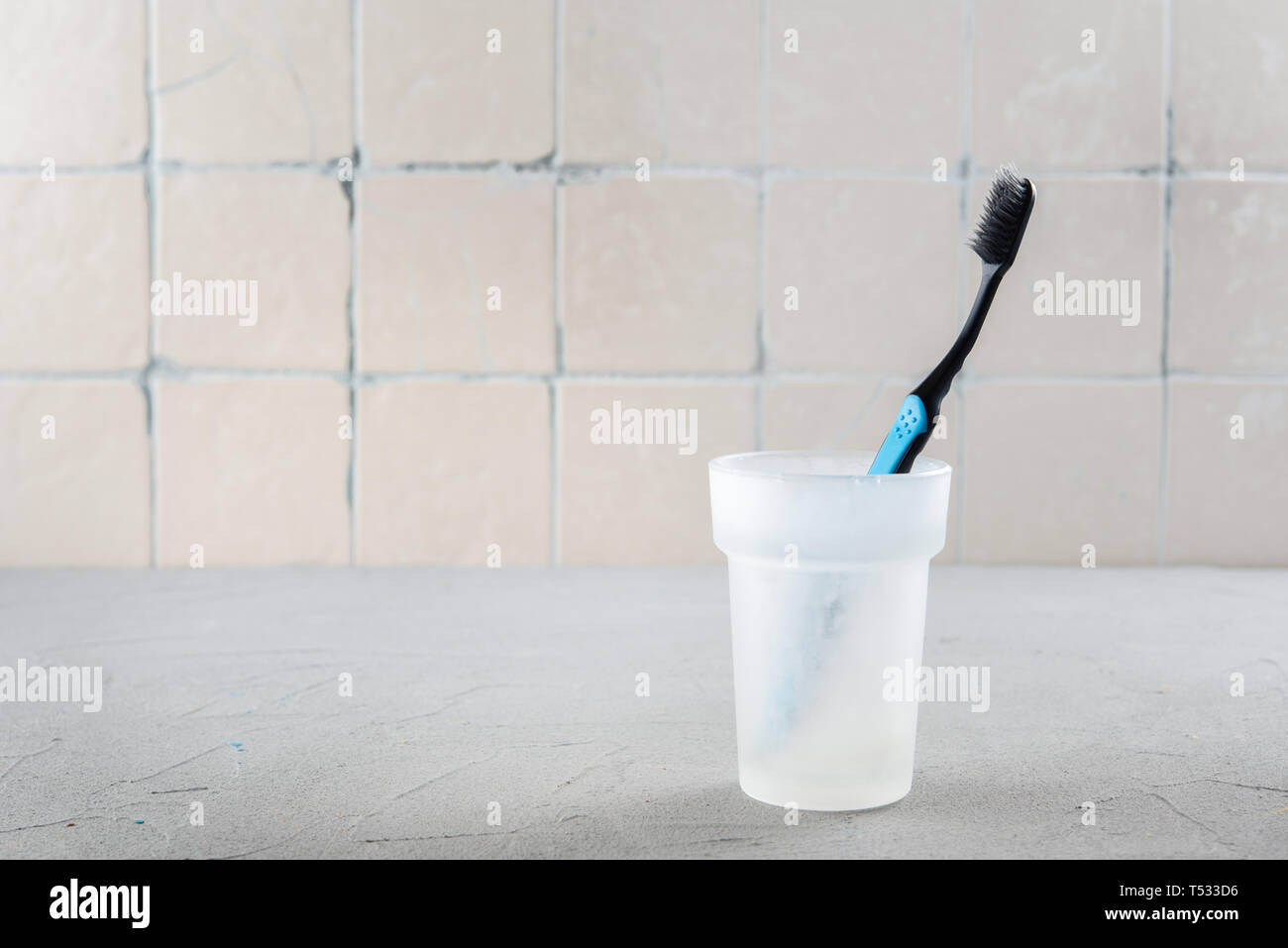 Toothbrush in the bathroom - close-up against the wall with ceramic ...