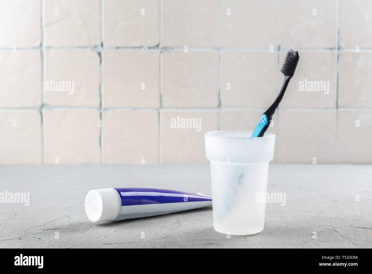 Toothbrush in the bathroom and toothpaste against the wall with ceramic ...