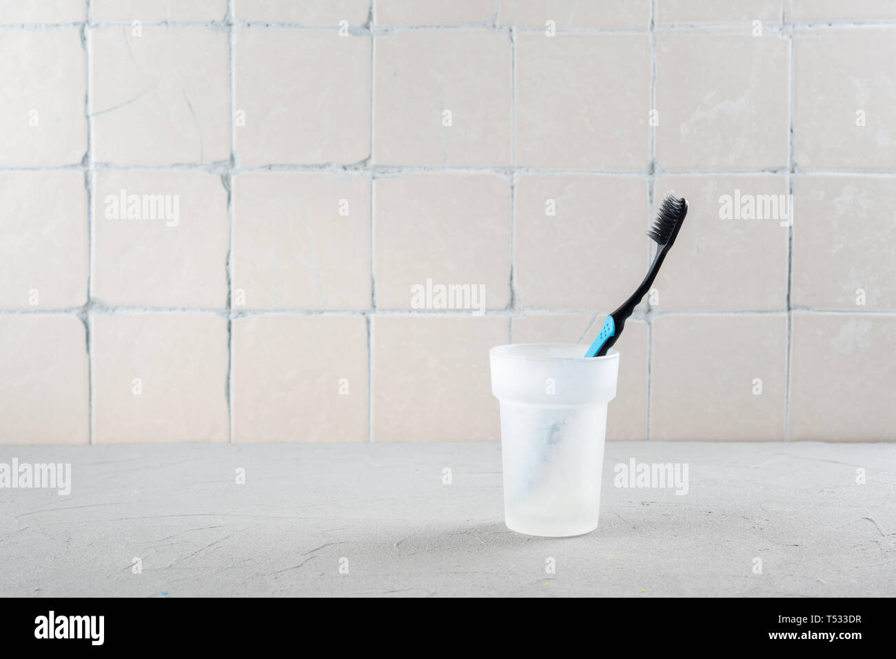 Toothbrush in the bathroom against the wall with ceramic tiles Stock ...