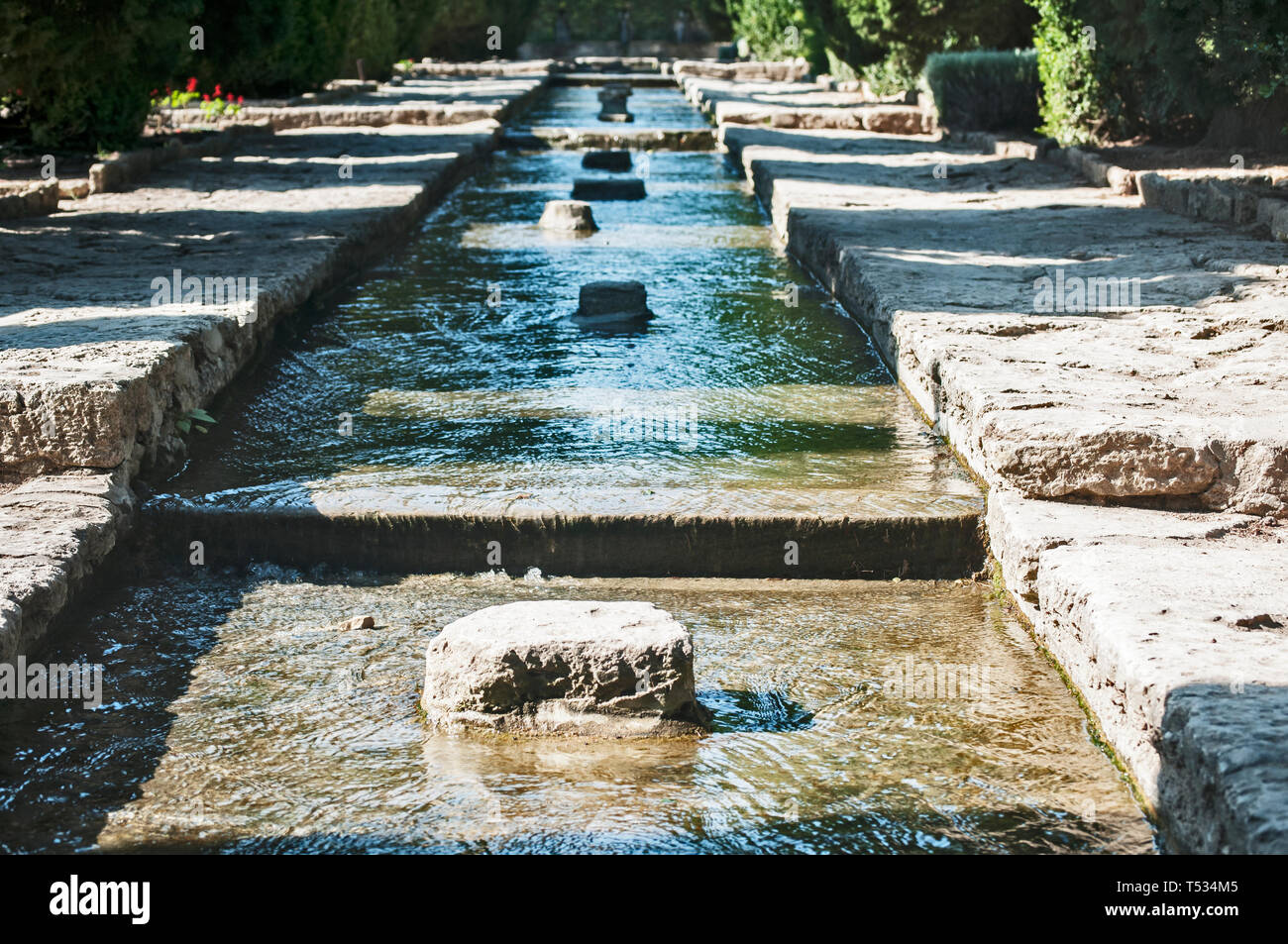 Clear water cascade stream in park garden with stone slabs bed Stock ...