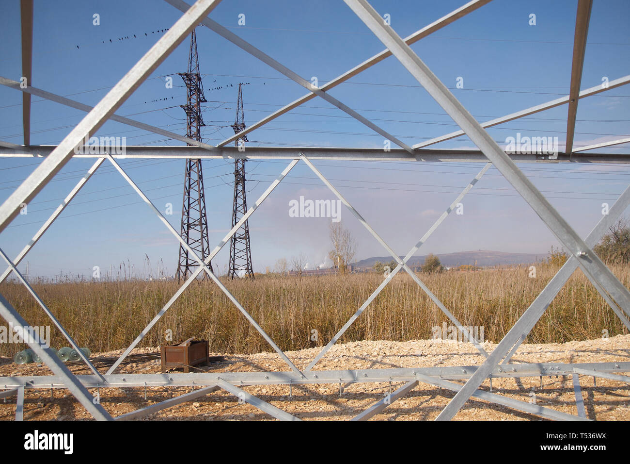 High-voltage power line in an industrial suburb. Installation of ...