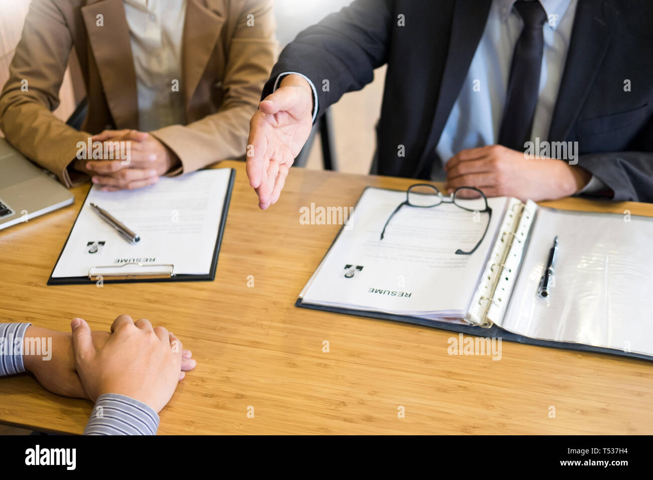 Job applicant having interview. Business young candidate people shaking ...