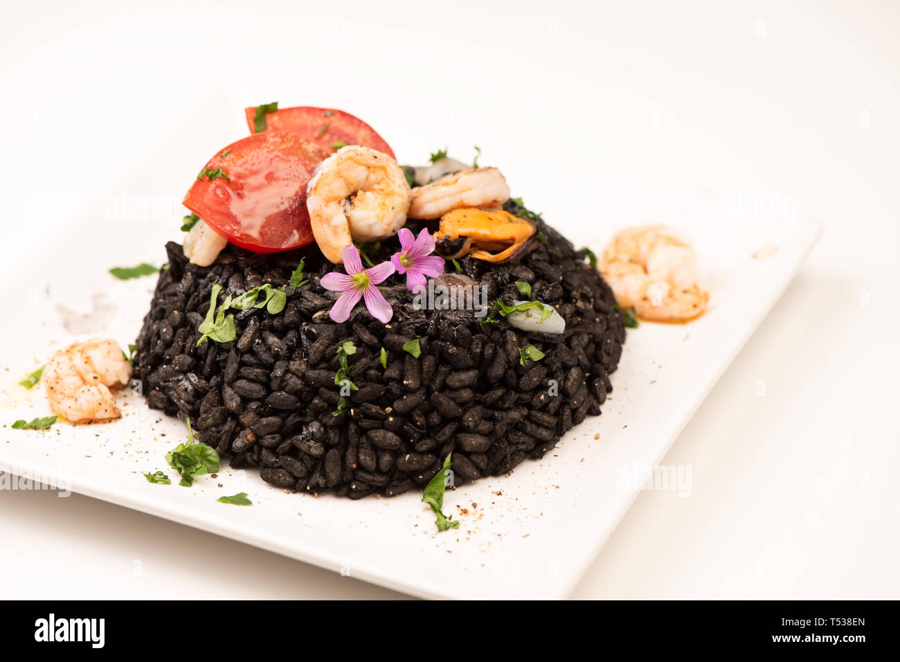 Seafood black Risotto with shrimps colored with Squid ink on white ...