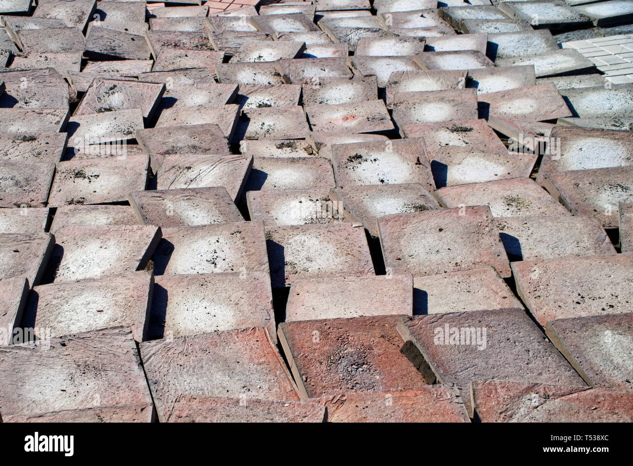 Old worn paving slabs during dismantling from a city street ...