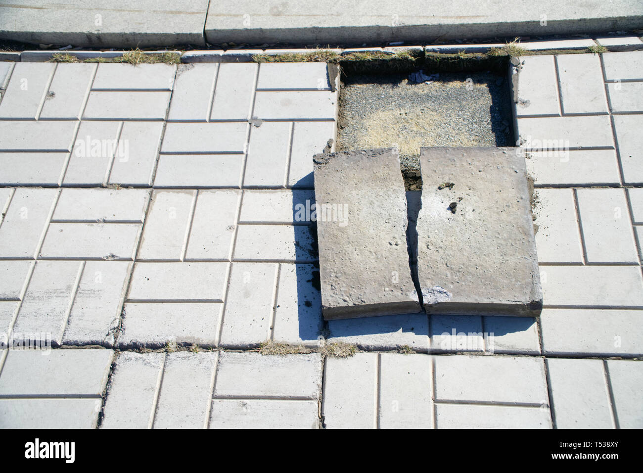 Old cracked pavement tiles, requiring dismantling and replacement ...