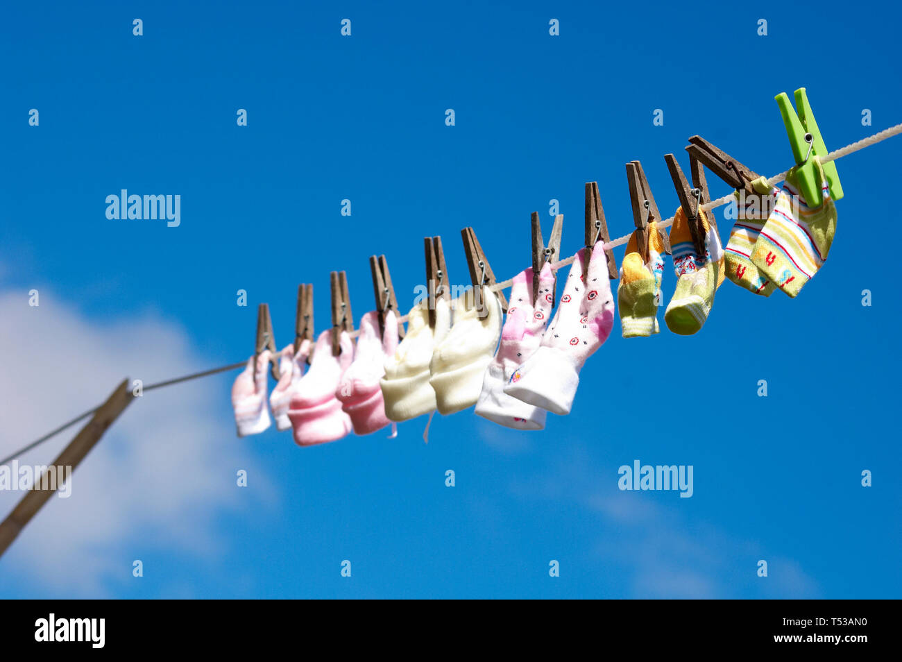 This images is about kids socks drying outside Stock Photo - Alamy