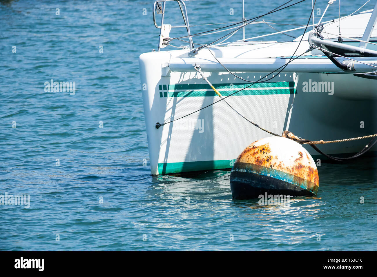 Rusty old float by the bow of an anchored boat Stock Photo - Alamy