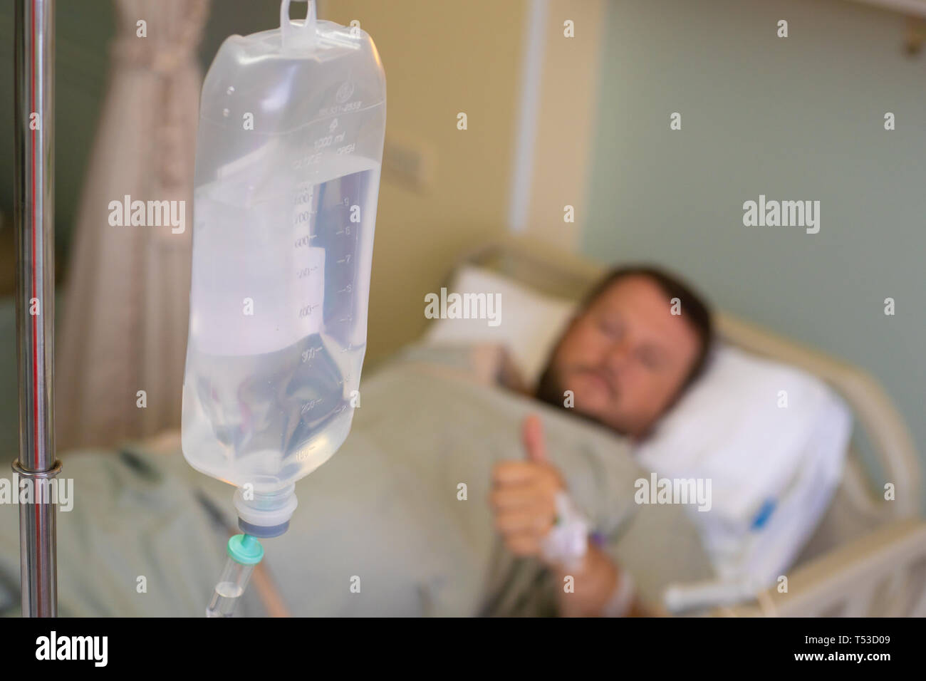 Close-up. Male hand with a dropper during chemotherapy in a hospital ...