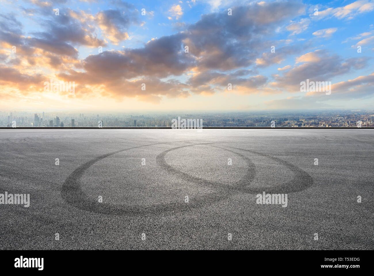 Shanghai city skyline and asphalt race track ground at sunrise,high ...