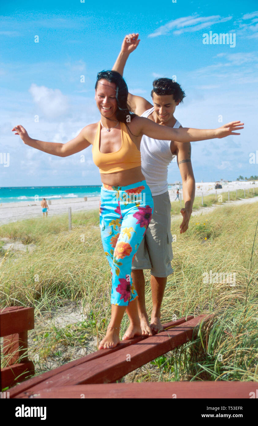 Male balance on boardwalk rail beach beaches hi-res stock photography ...
