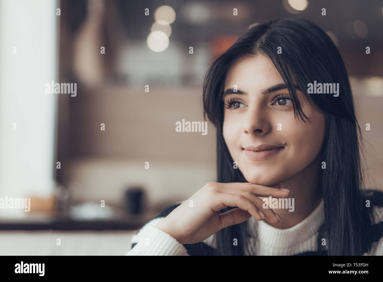 Beautiful Caucasian Girl In Casual Clothes Smiling While Sitting In