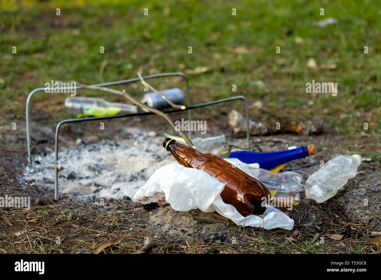 A pile of garbage in the forest park near the campfire site ...