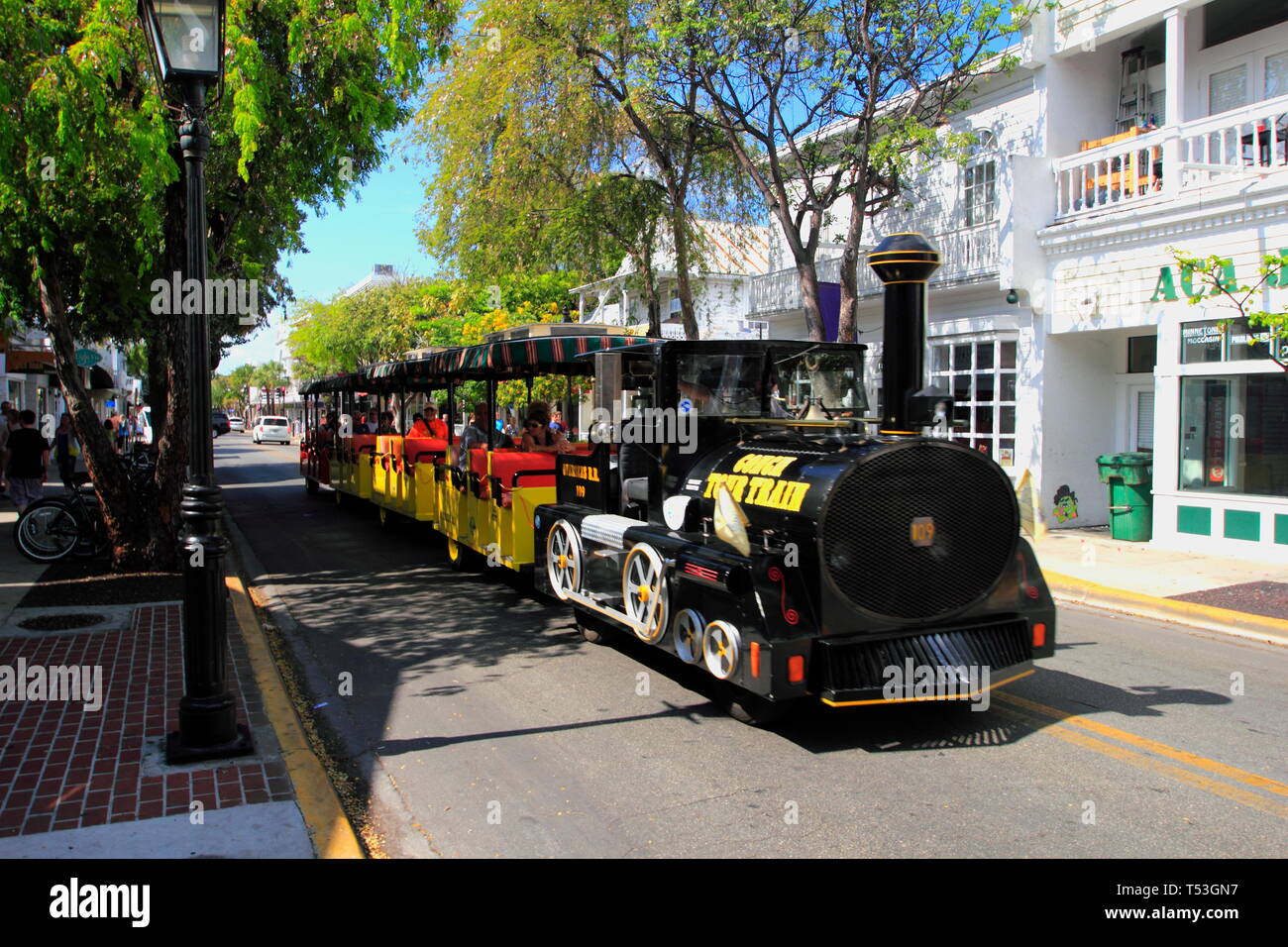 duval street and the conch train in key west florida Stock Photo - Alamy