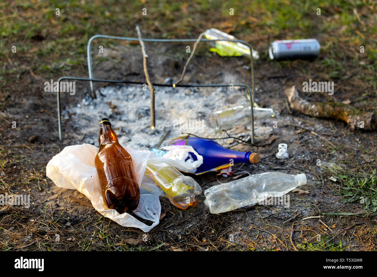 A pile of garbage in the forest park near the campfire site ...