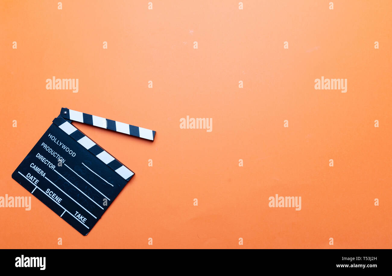Cinama film concept. Movie clapper board on orange color background ...