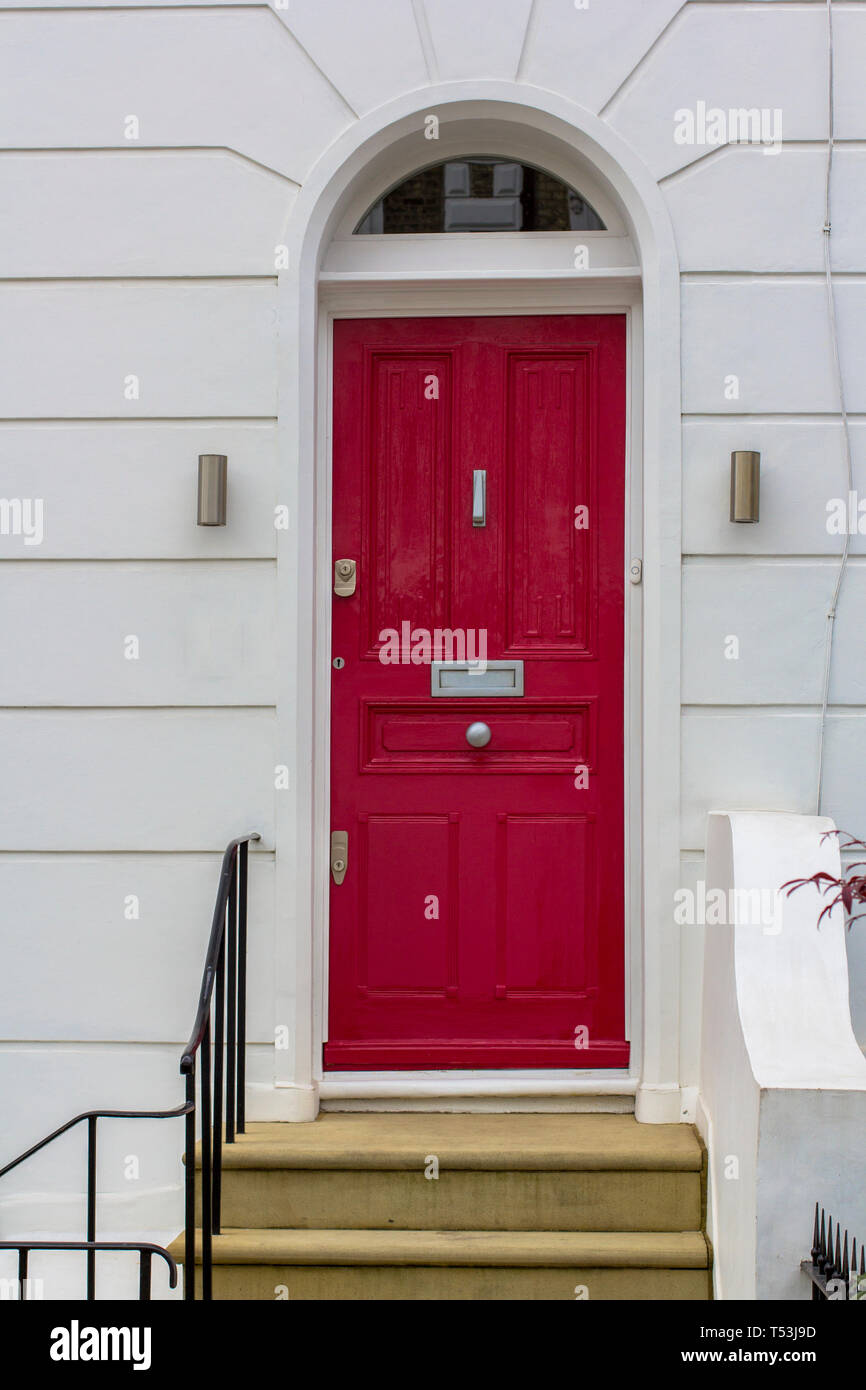 Red Wooden Entrance Door to residential building in London. Typical ...