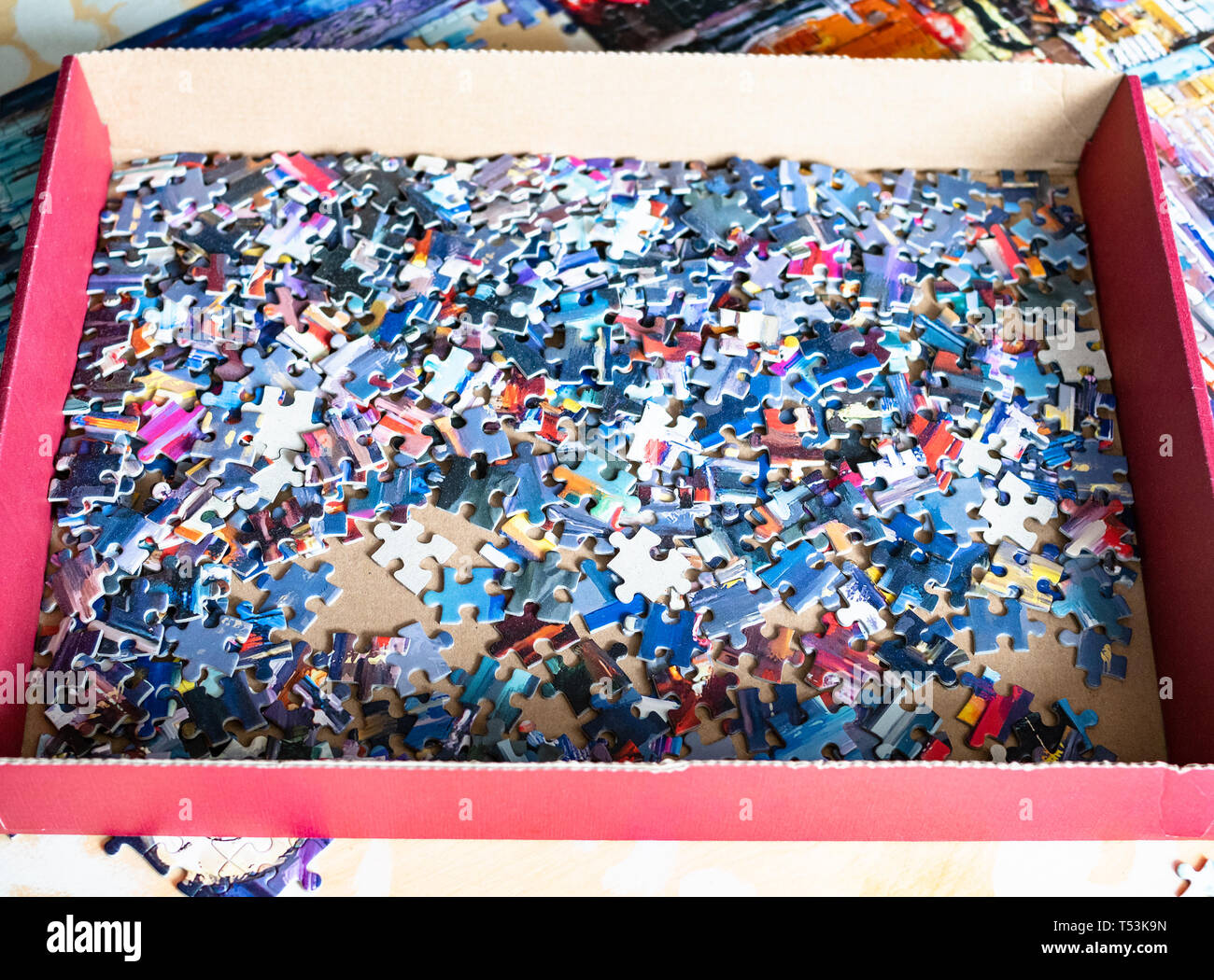 box with disassembled jigsaw puzzle board game on table with partly ...