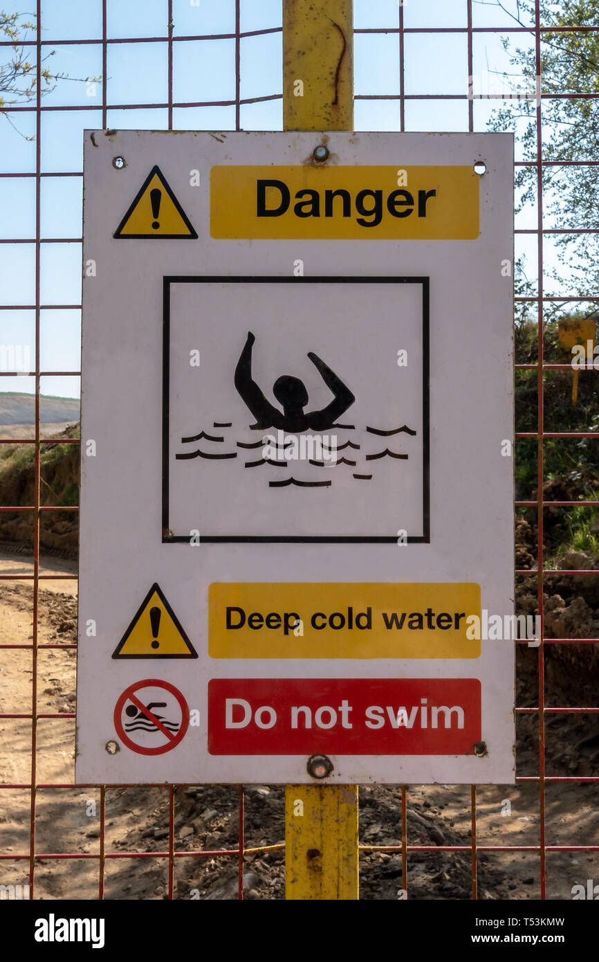 Yellow and black warning sign about deep water hi-res stock photography ...