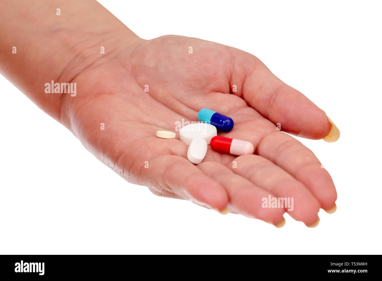 Pills on the palm of female hand. Hand of woman holding pills. Pills on ...