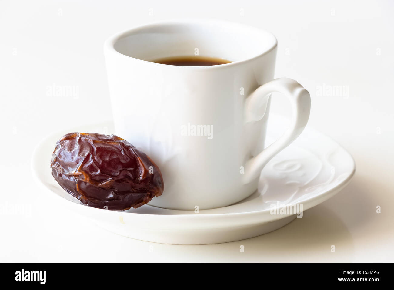 White cup of coffee and one dates white background isolated Stock Photo ...