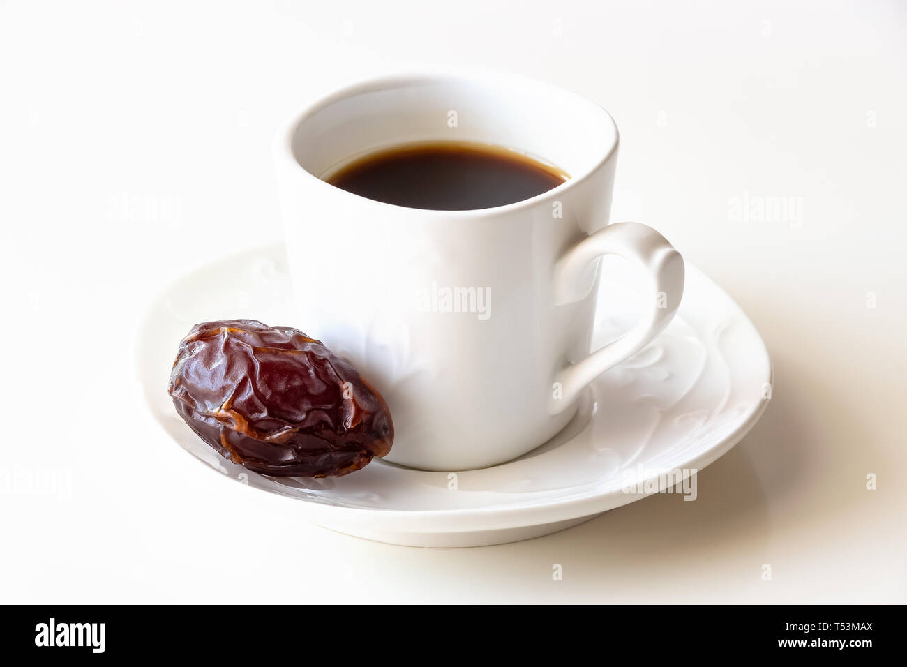 White cup of coffee and one dates white background isolated Stock Photo ...