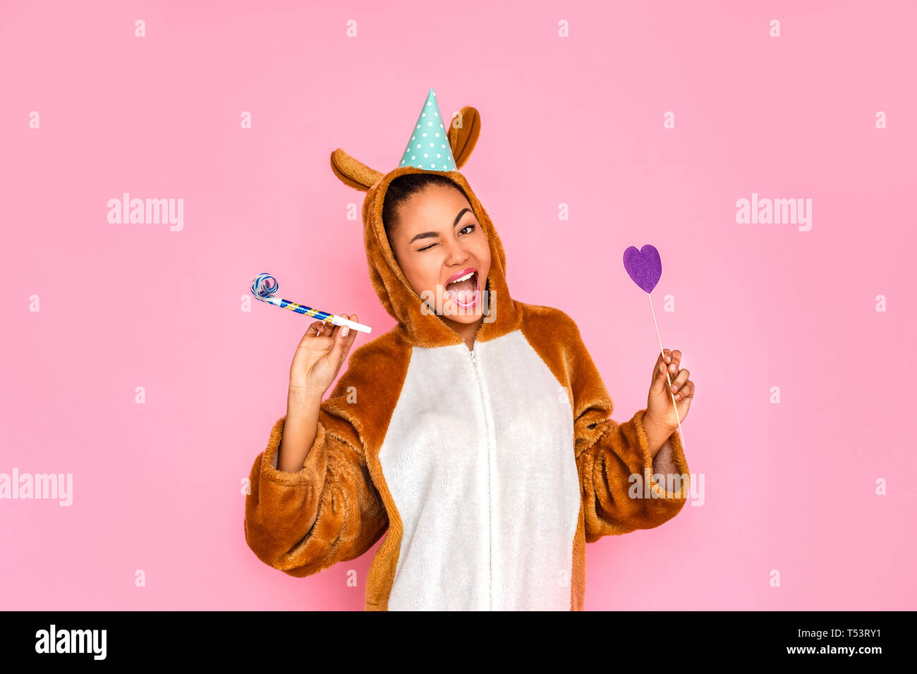 Young Woman In Bunny Kigurumi Wearing Party Hat Standing Isolated On