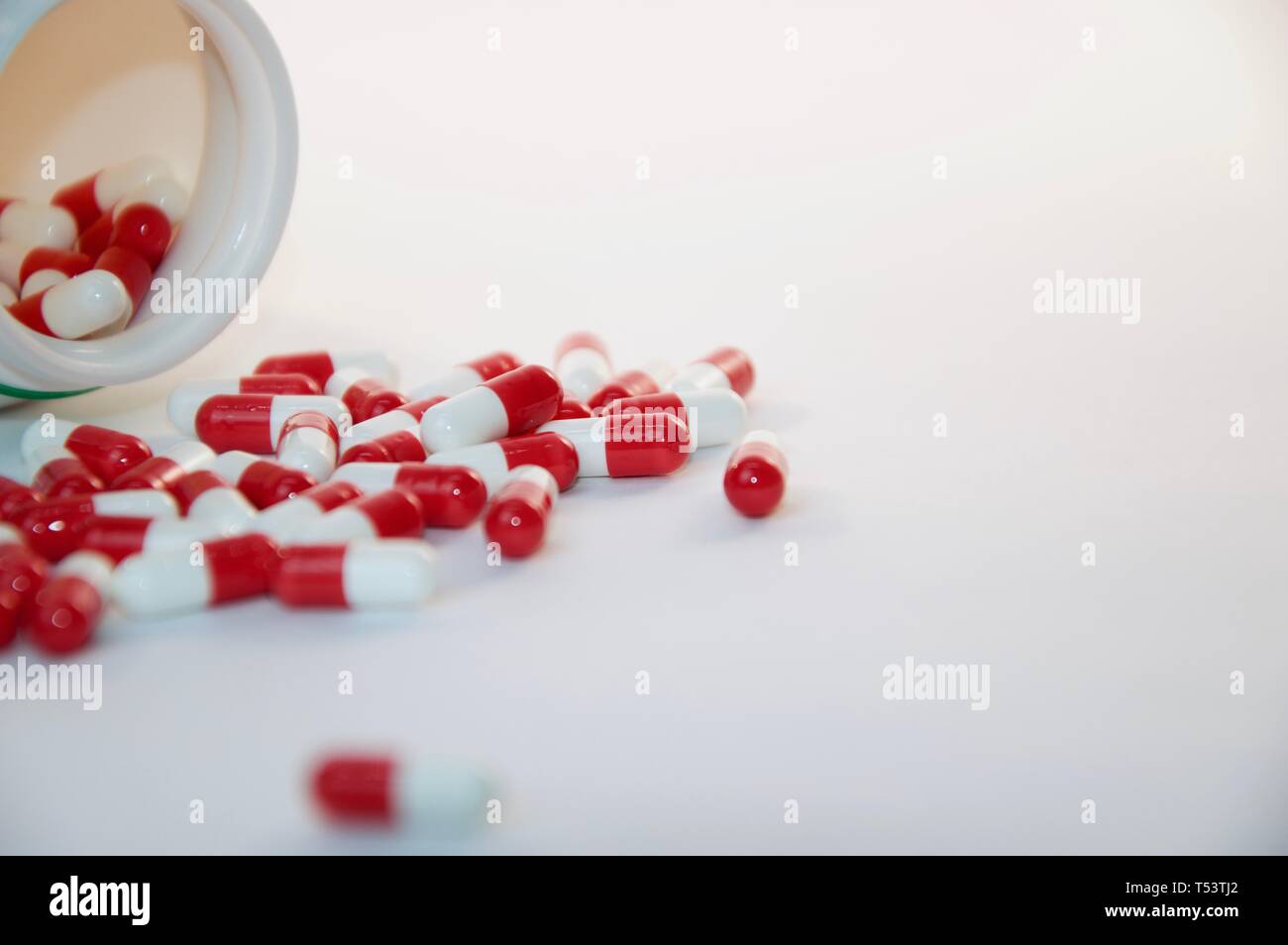 White and red capsules isolated Stock Photo - Alamy