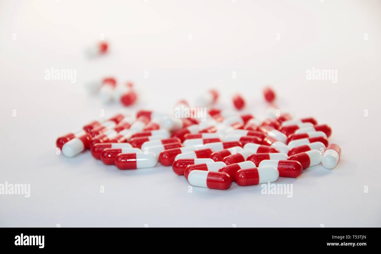 White and red capsules isolated Stock Photo - Alamy