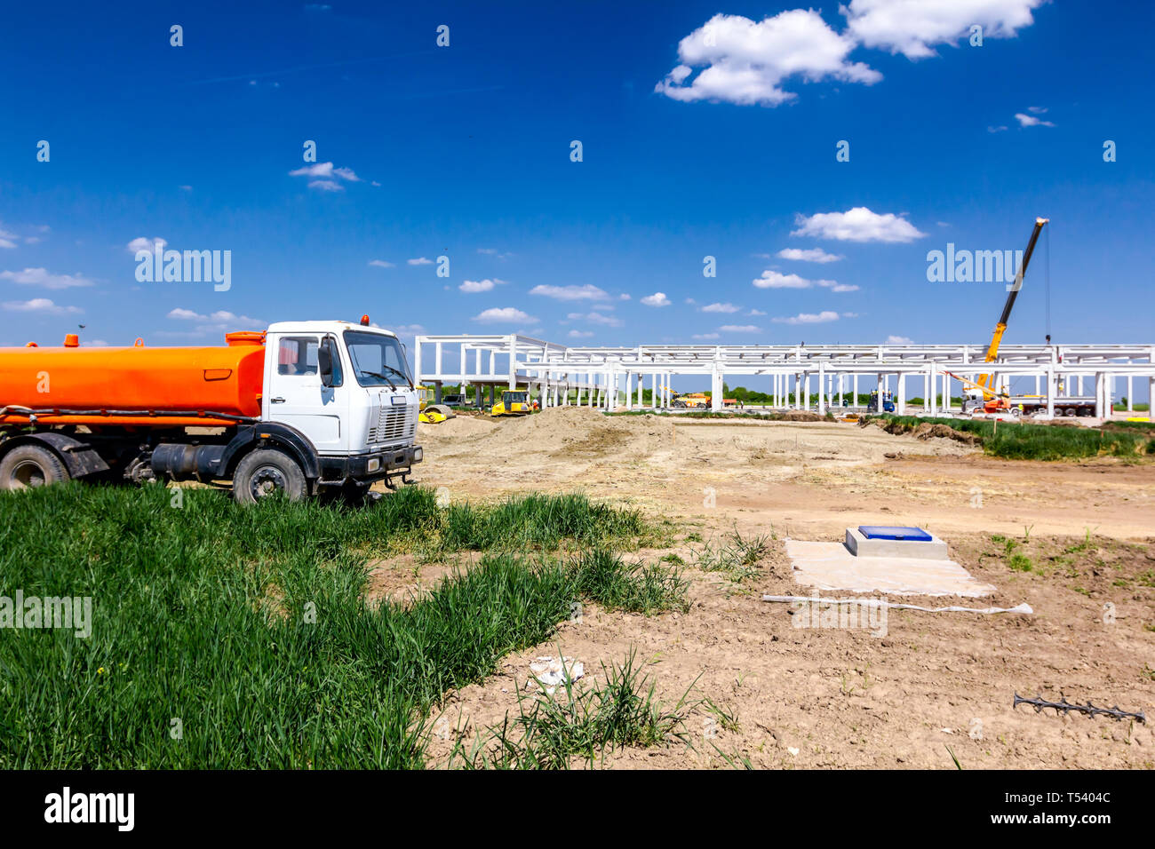 Assembly a huge concrete skeleton of industrial building with machinery ...