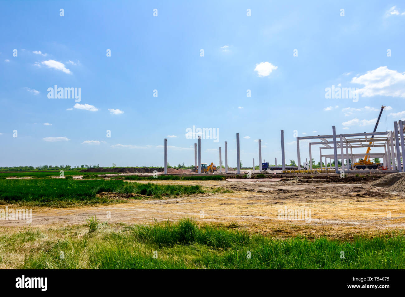Assembly a huge concrete skeleton of industrial building with machinery ...