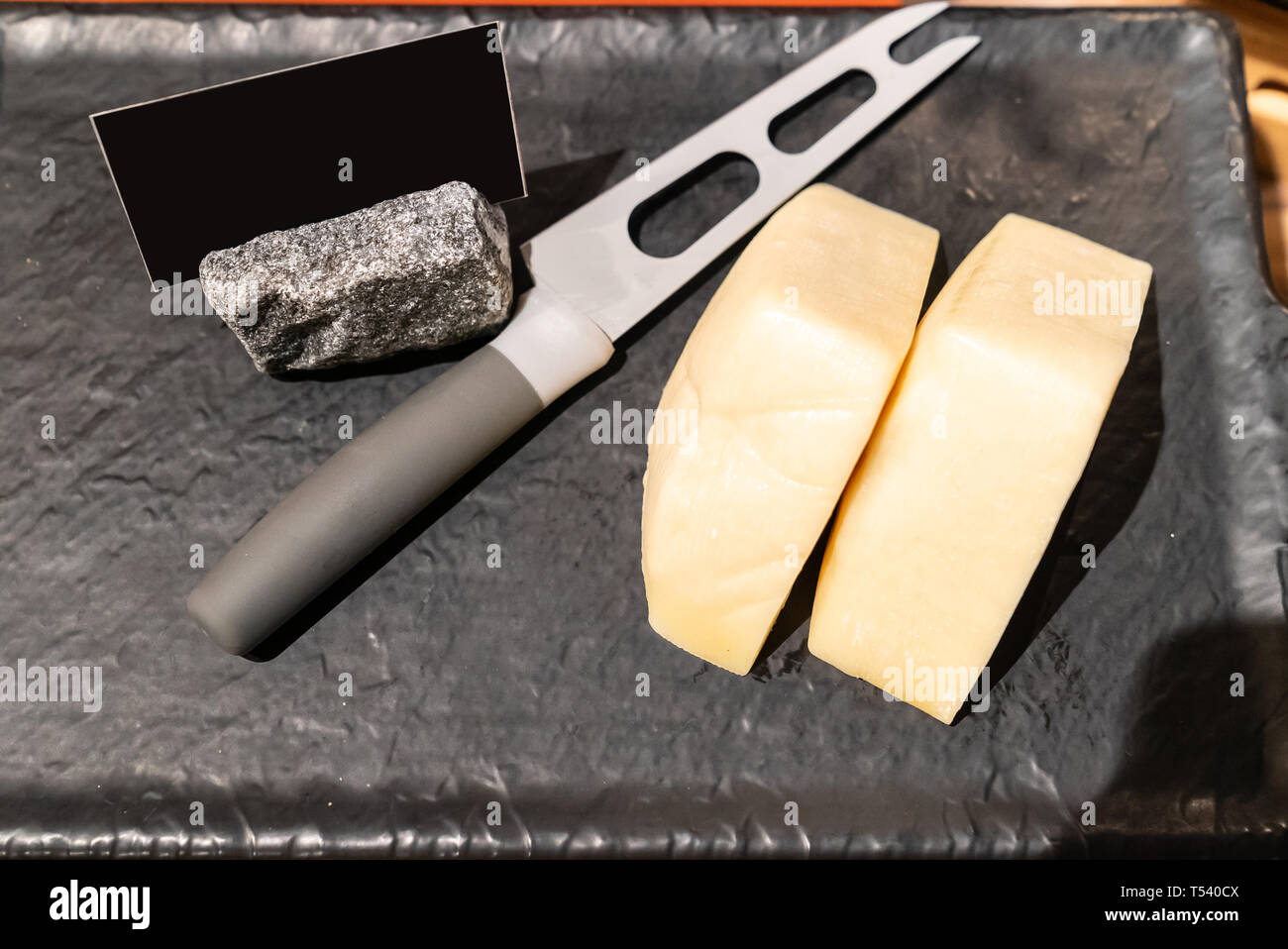 edam cheese on black stone plate in buffet line Stock Photo - Alamy
