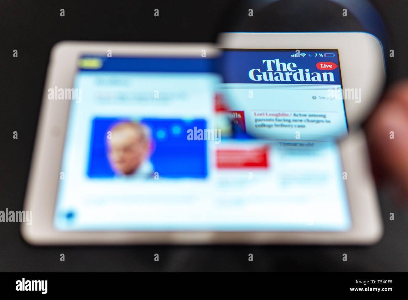The Guardian News website homepage on the tablet screen. Guardian News ...