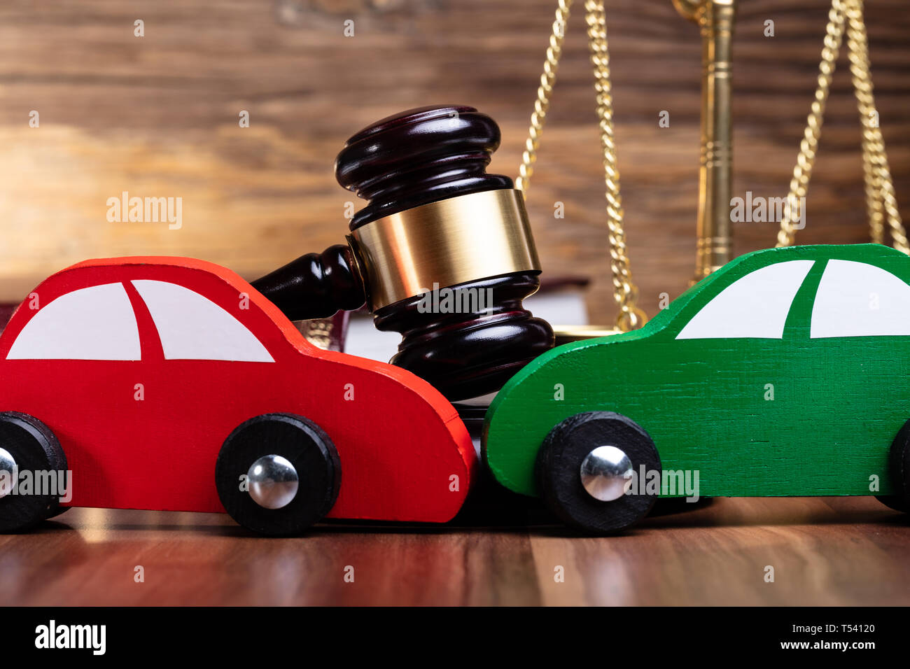 Close-up Of Two Green And Red Wooden Cars On Desk In Courtroom Stock ...