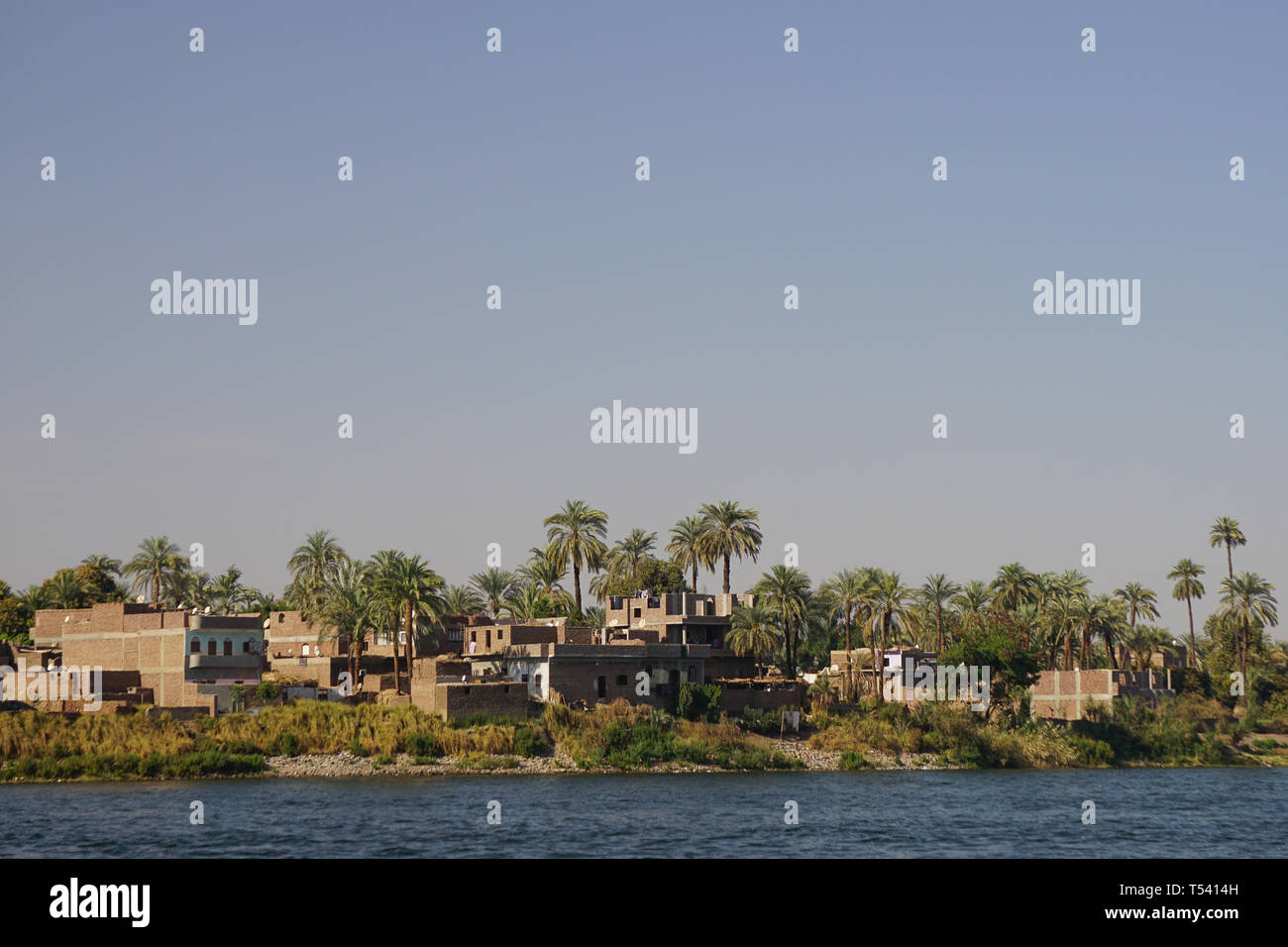 Nile River, Egypt: Houses and palm trees line the east bank of the Nile ...