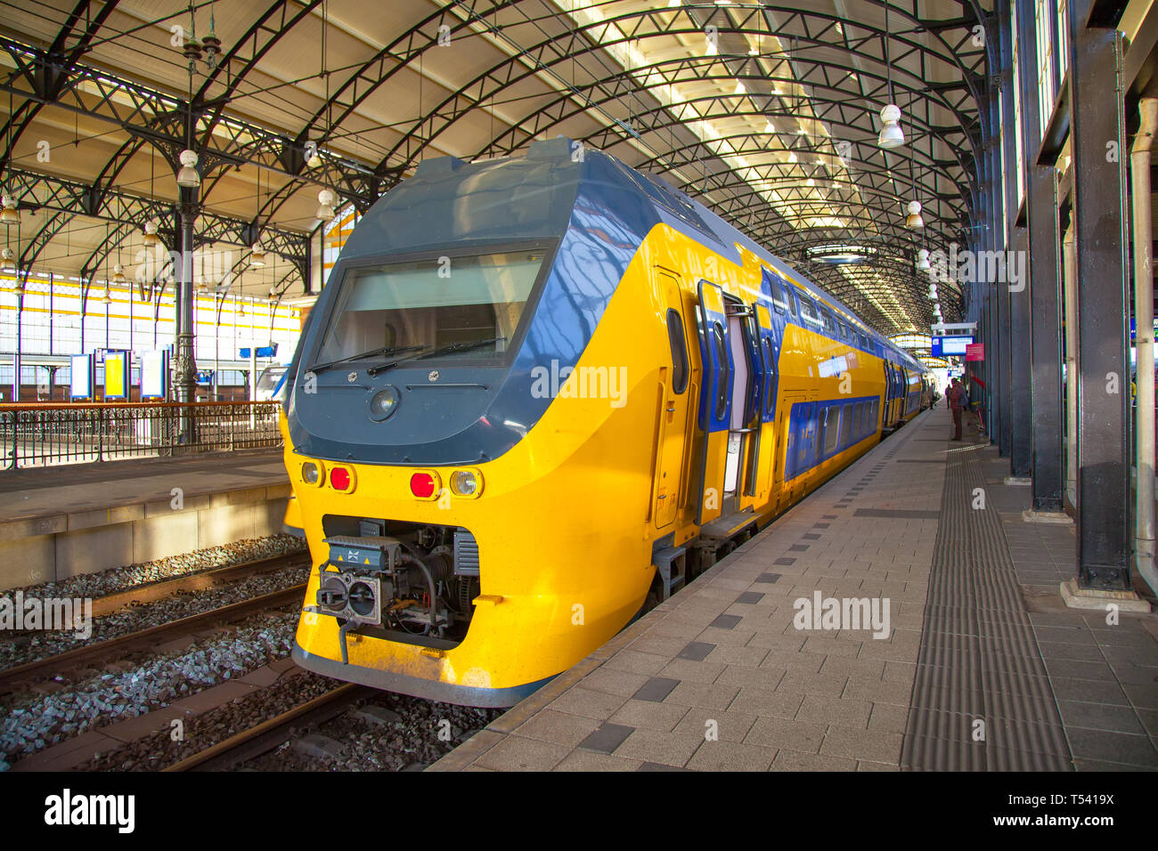Railway Station Amsterdam Centraal. In front of yellow Yellow-blue ...