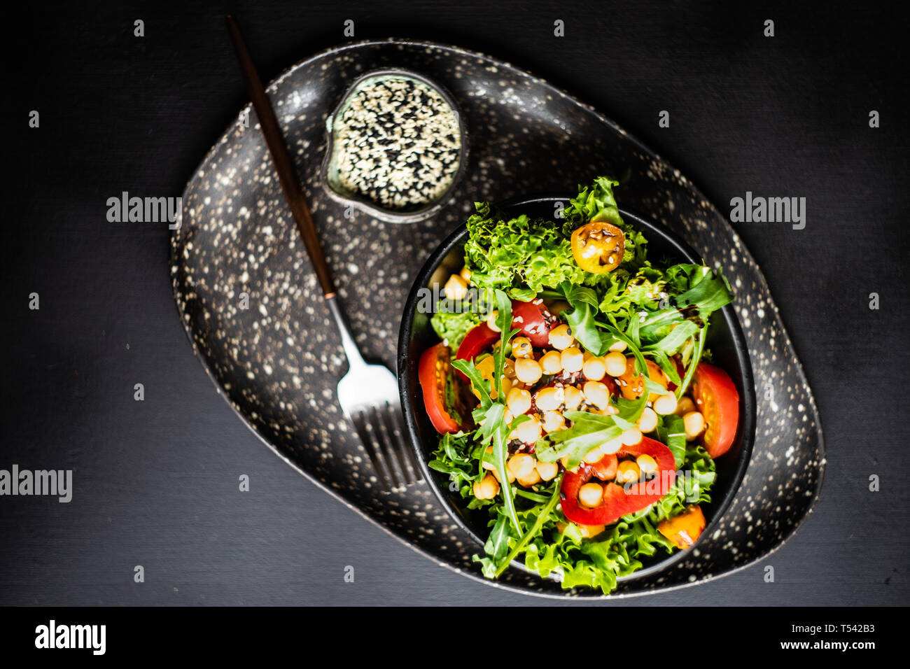 Summer salad with organic vegetables like a tomatoes, pepper, rocket ...